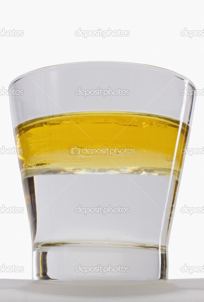 Oil floating on water surface in a glass — Stock Photo © imagedb_seller ...