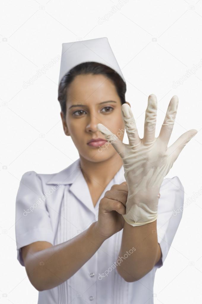 Nurse wearing a surgical glove — Stock Photo © imagedb_seller #33026473