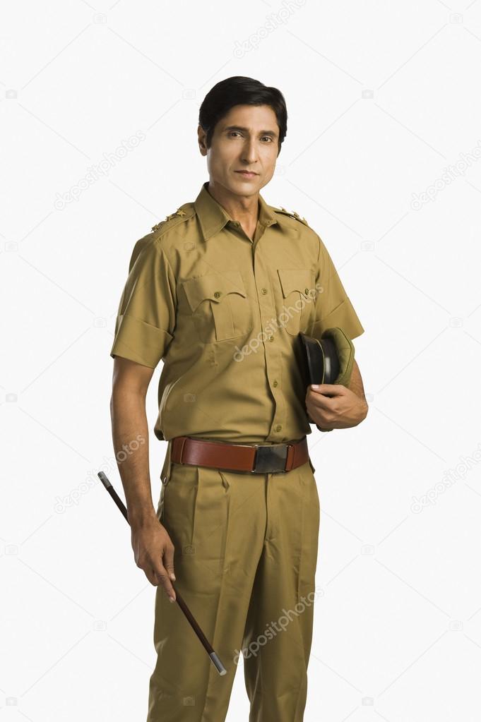 Police officer holding a nightstick and a cap — Stock Photo © imagedb ...