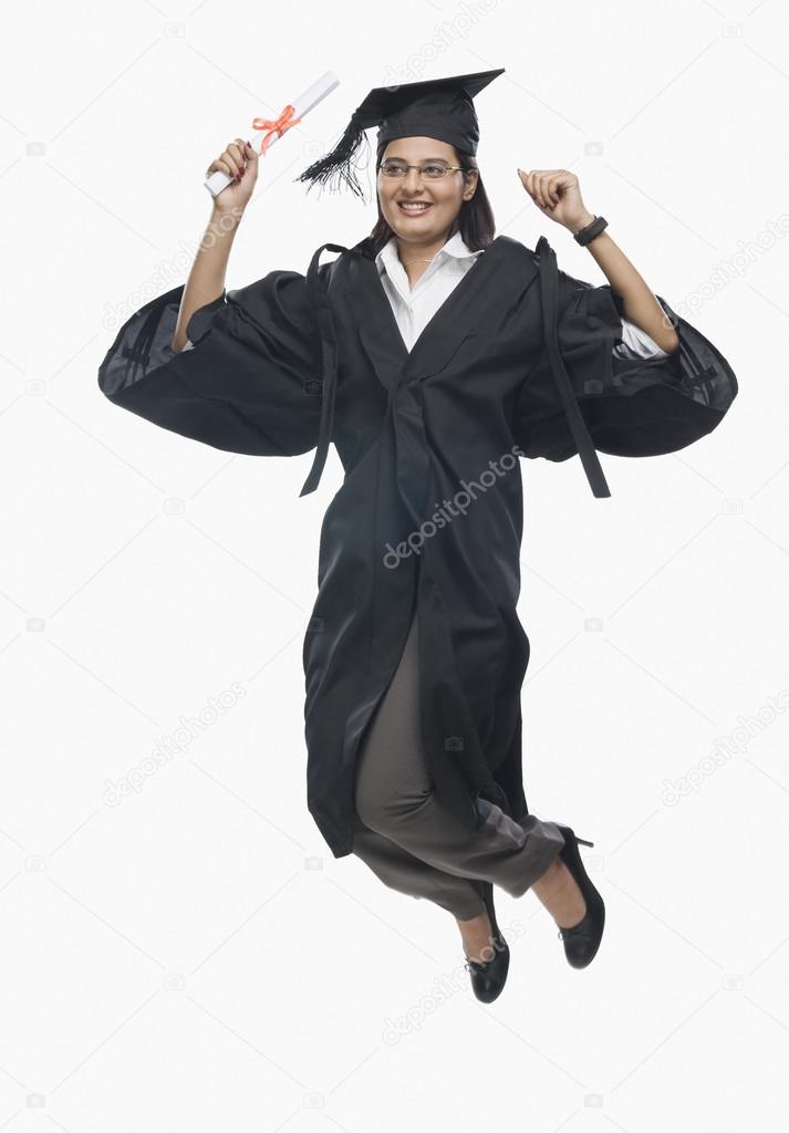 Woman jumping with her diploma Stock Photo by ©imagedb_seller 33043533