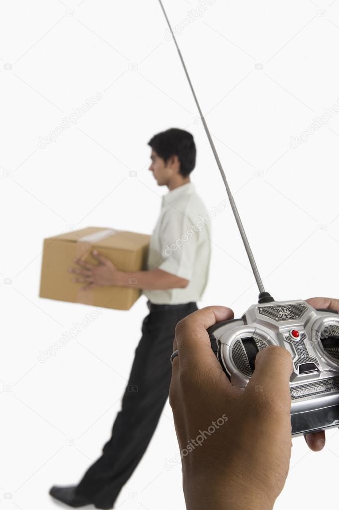 Person's hands controlling a worker with a remote control — Stock Photo ...