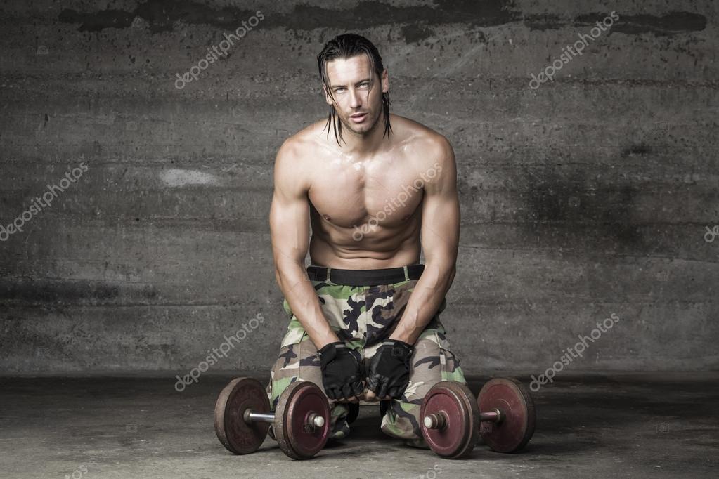 Exhausted athlete resting from weight training Stock Photo by ...