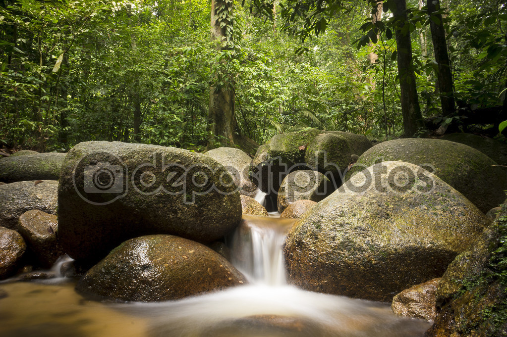 Fresh water stream waterfall with rock formation in tropical rainforest ...