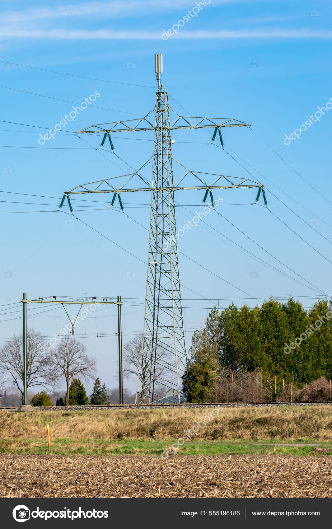 High Voltage Power Lines Field — Stock Photo © Wirestock #555196186