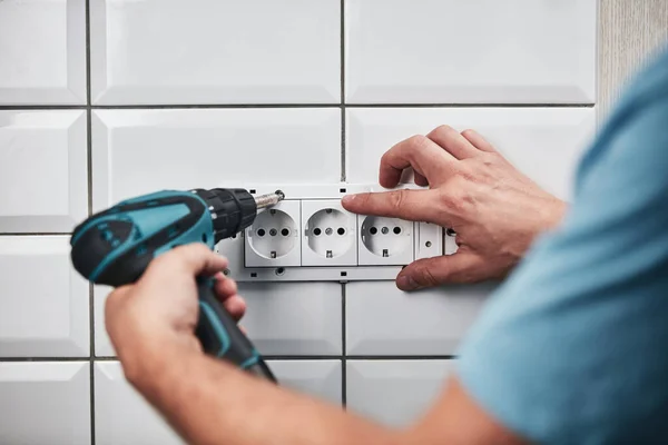 Electrician repairing and fixing wires in the electrical socket ...