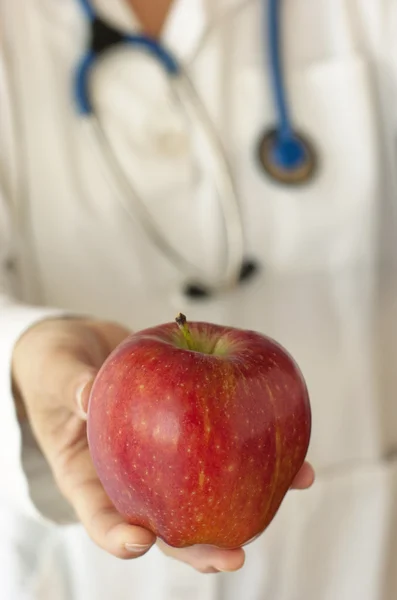 Doctor man with a red apple and a measuring tape — Stock Photo ...