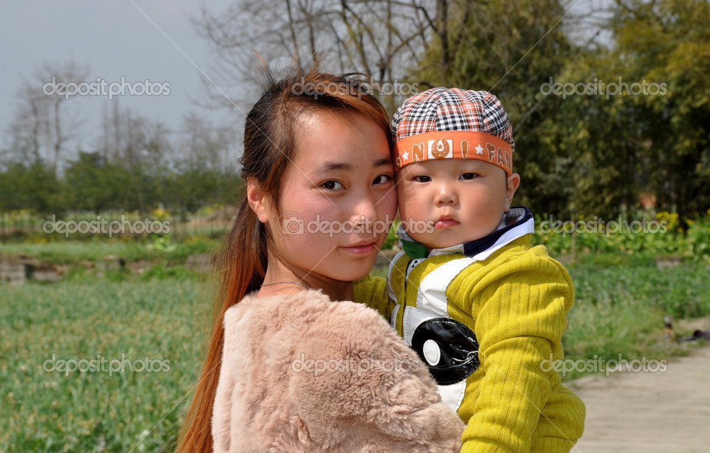 Pengzhou, China: Mother Holding Baby – Stock Editorial Photo ...