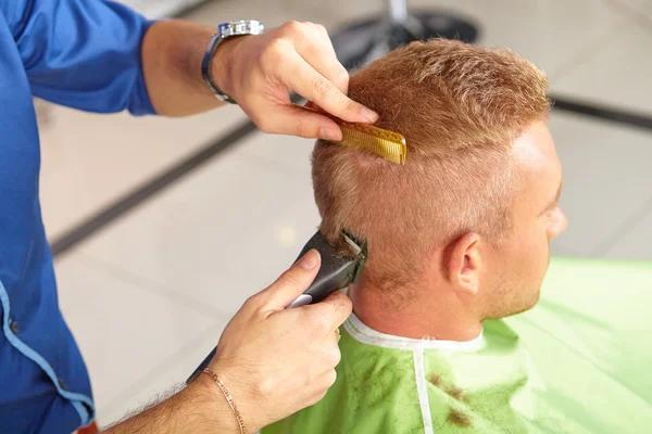 Hair salon. Hairdresser does haircut for man. - Stock Image - Everypixel
