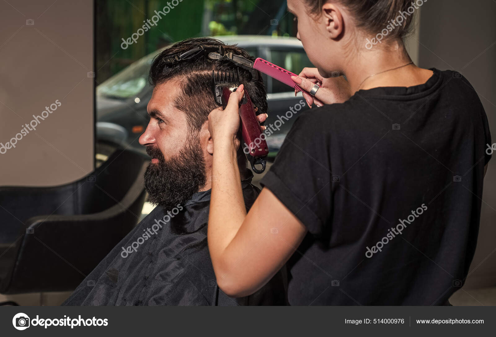 Master Barber does the hairstyle and styling with electric shaver to ...