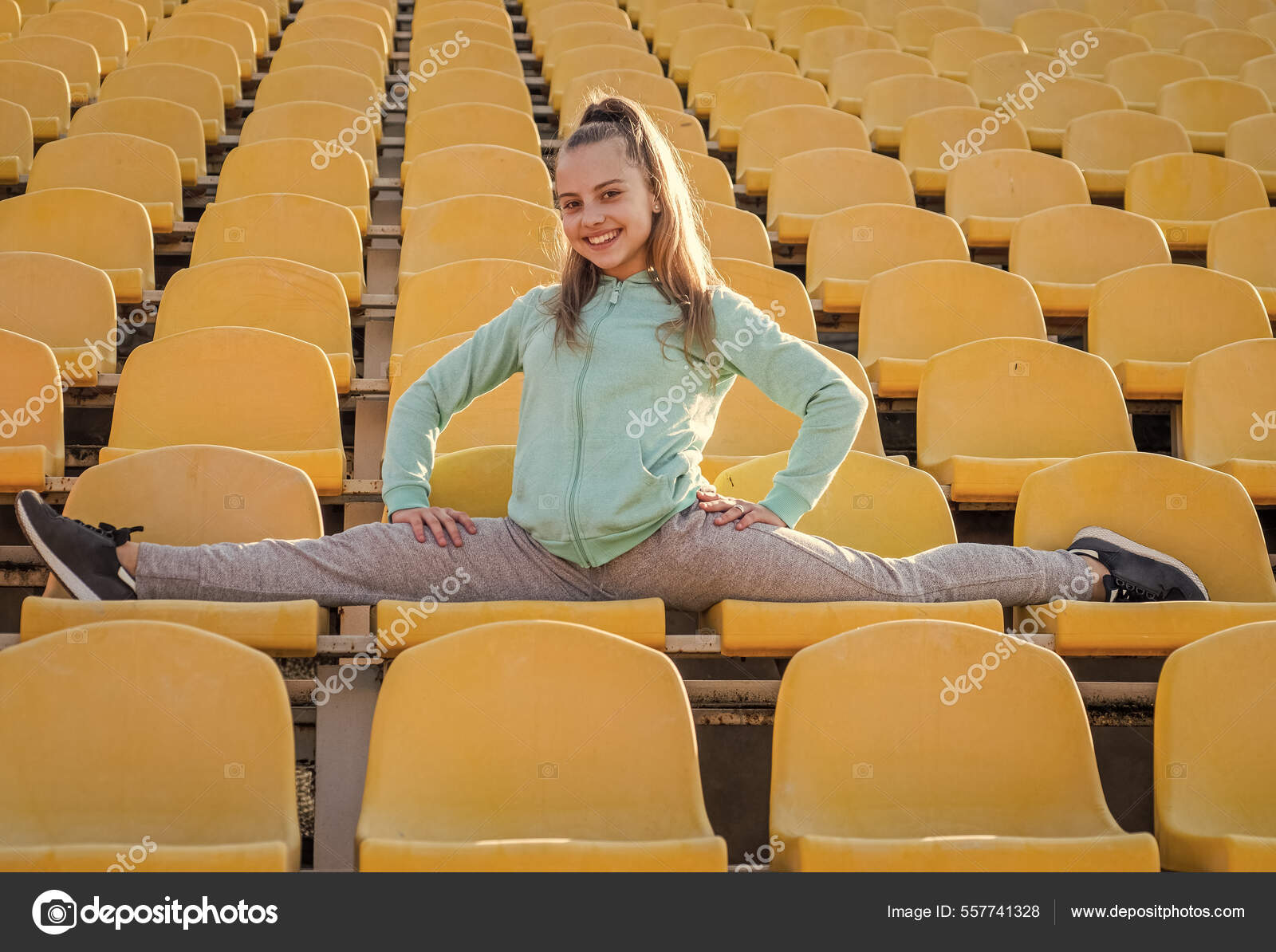 Stretch and flex for your health. Flexible tween do splits on stadium ...