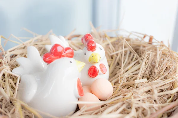 Chicken family ceramic on straw nest in straw nest - Stock Image ...