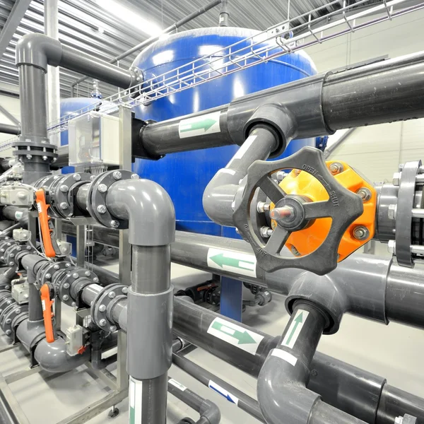 New plastic pipes and colorful equipment in industrial boiler room ...