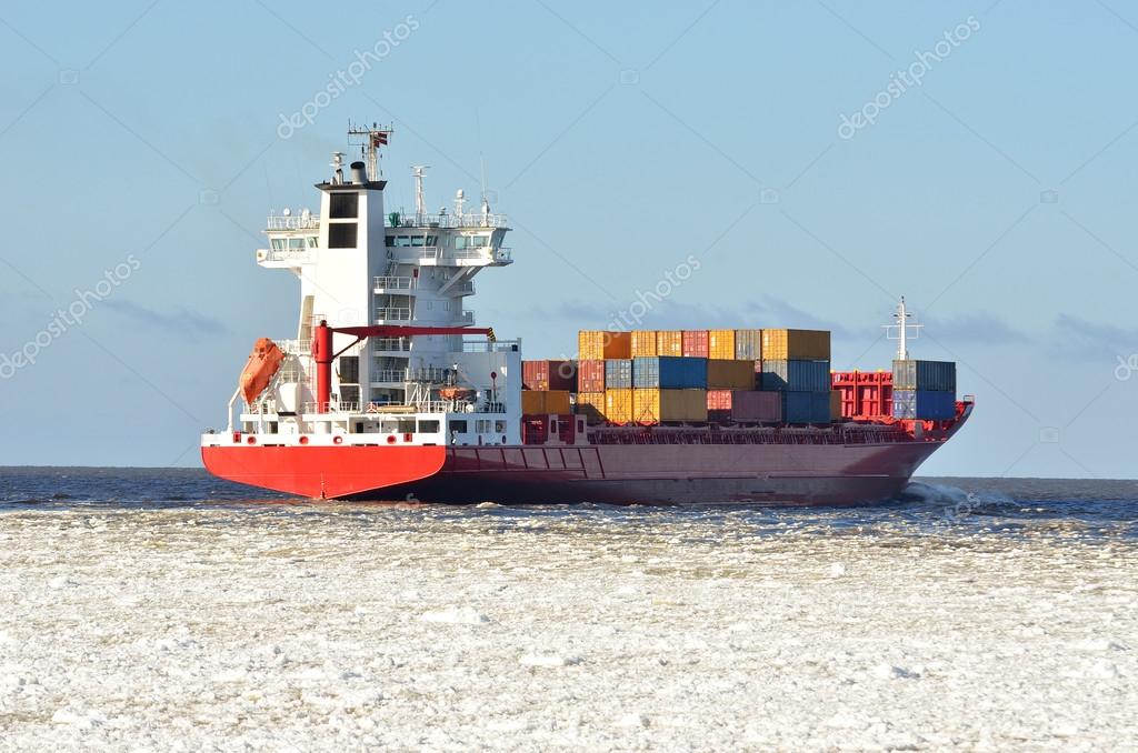Cargo container ship sailing in sea full of ice in winter Stock Photo ...