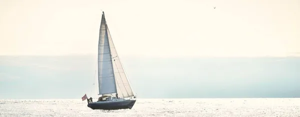 Blue sloop rigged yacht sailing in an open Baltic sea on a clear day ...