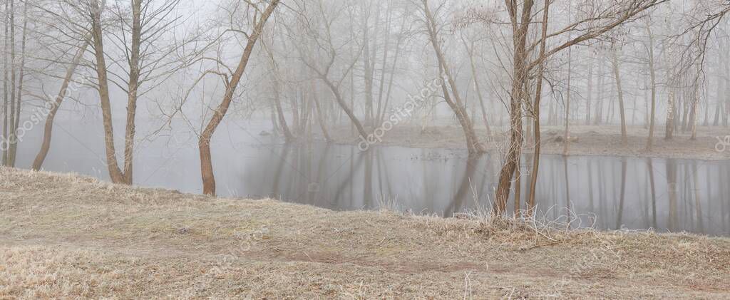 Small river (lake. pond) in a forest park. Frost, snow, mist, soft ...