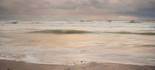 Baltic sea at sunset. Dramatic sky, blue and pink glowing clouds ...