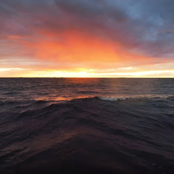 Dramatic sunset sky above the sea. Colorful glowing golden and pink ...