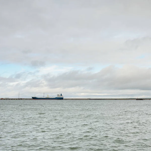 Baltic sea after the storm. Cargo port terminal. Dramatic sky. glowing ...