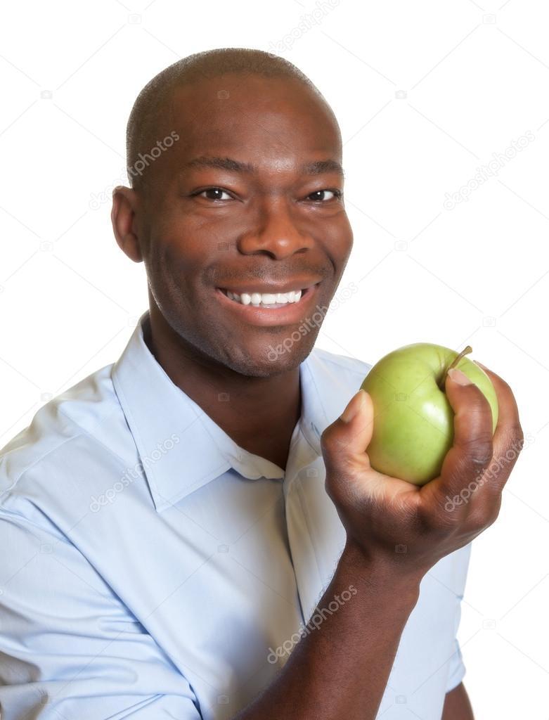 African man eating an apple — Stock Photo © kadettmann #32970151