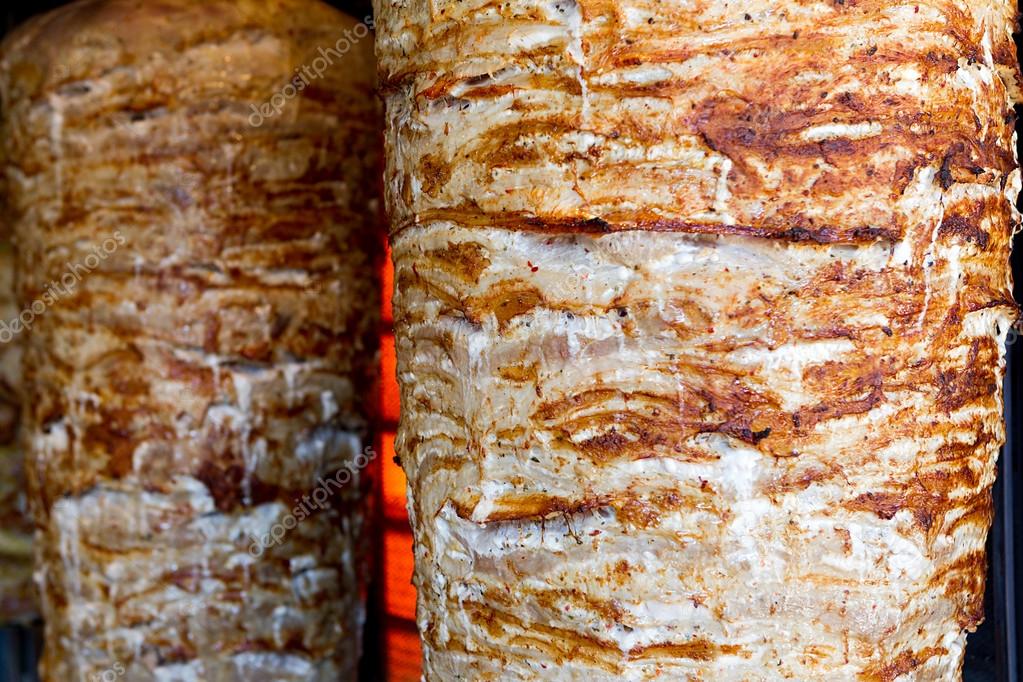 A pair of rotating skewered chicken and lamb meat grilled and re Stock ...