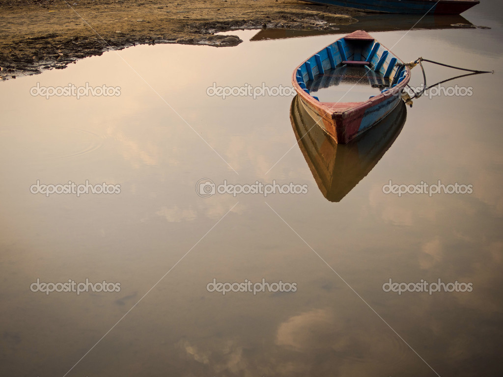 Rowing Boat Floating on the Still Waters of a Lake Stock Photo by ...
