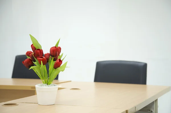 Red flower on Meeting room table - Stock Image - Everypixel