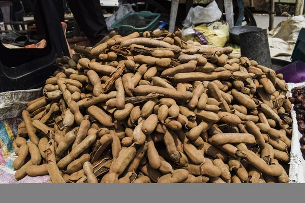 Tamarind fruit with shell sold in Vegetable Sunday market. Imli selling ...