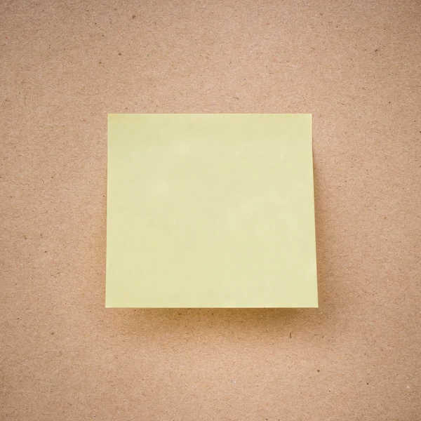 yellow sticky note message on brown paper texture close up — Stock ...