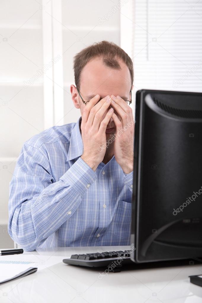 Overworked businessman frustrated and stressed in his office wit Stock ...