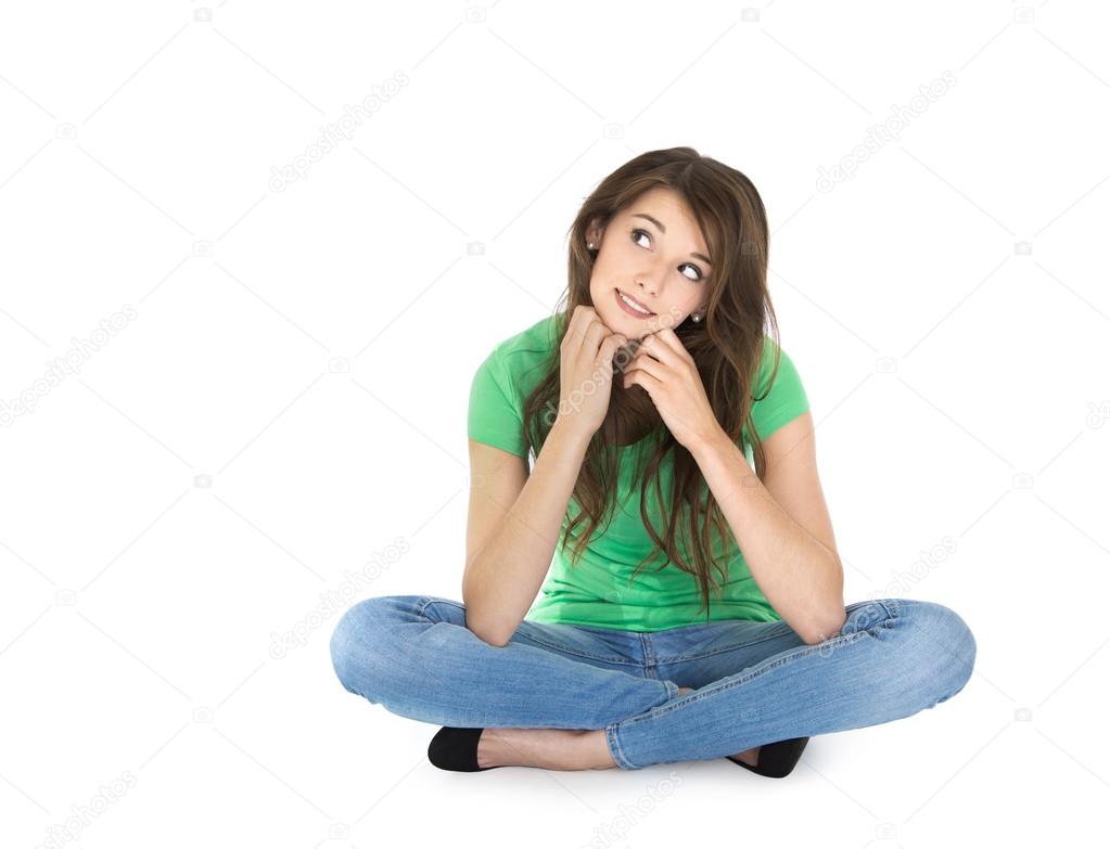 Isolated young reflective woman sitting with crossed legs. — Stock ...