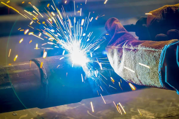 Pipe welding. The connection of the pipe with a clamp. Welder performs ...