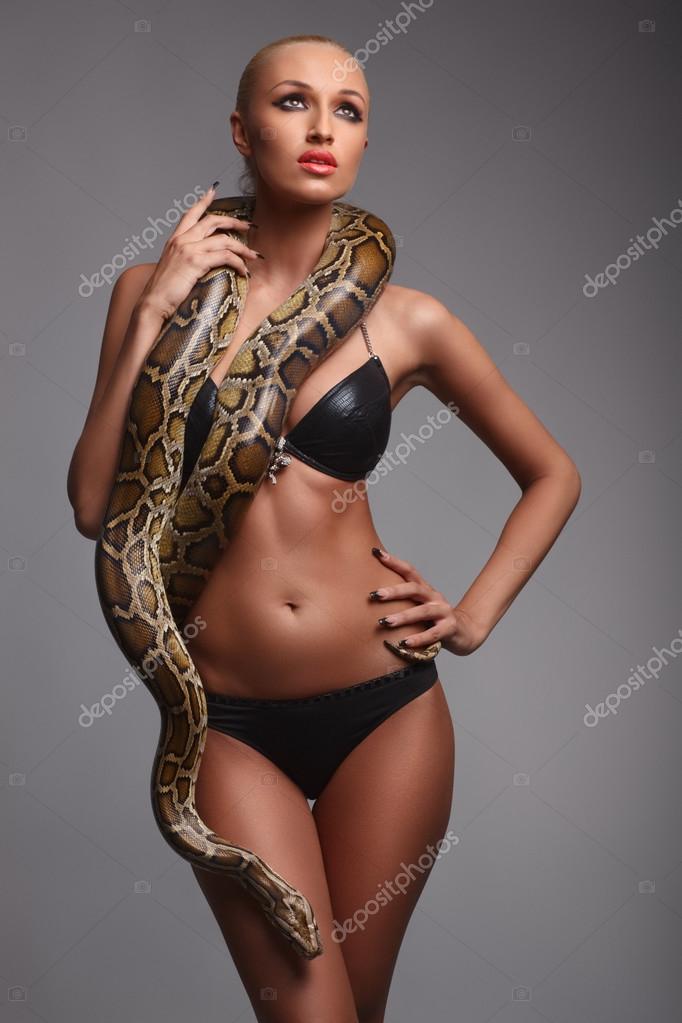 Girl with python — Stock Photo © evarlamov #34692055