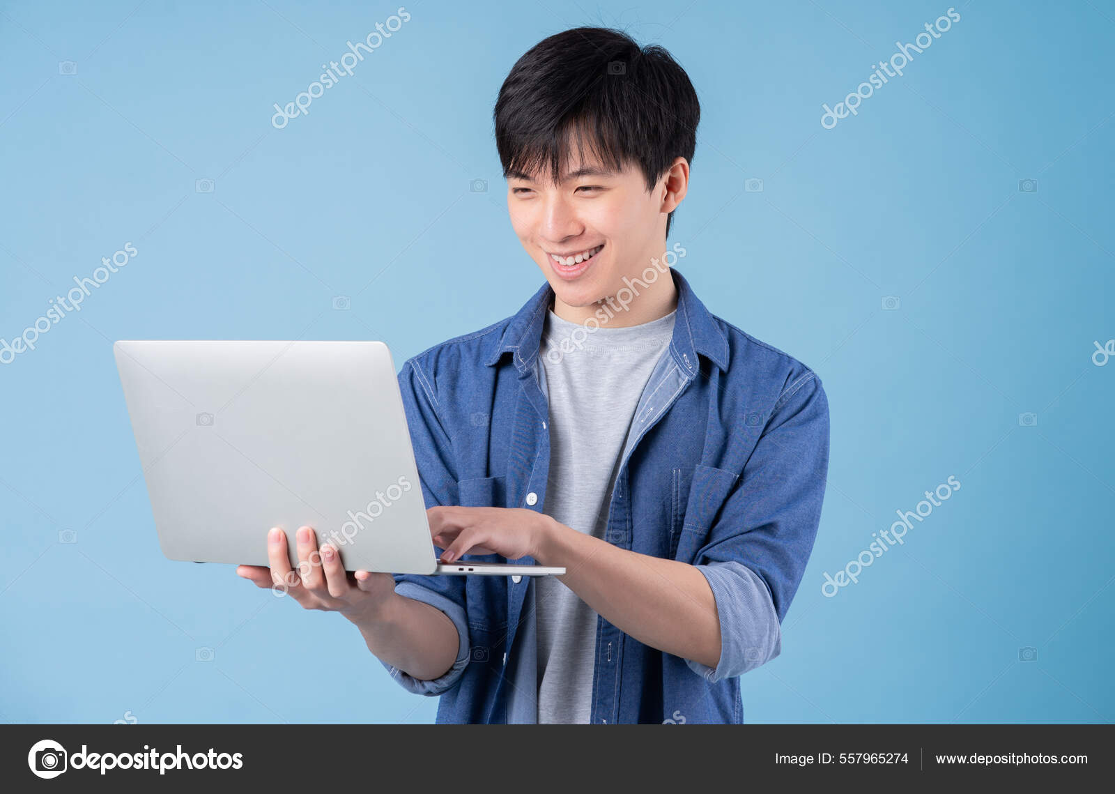 Young Asian Man Using Laptop Blue Background — Stock Photo © havucvp ...