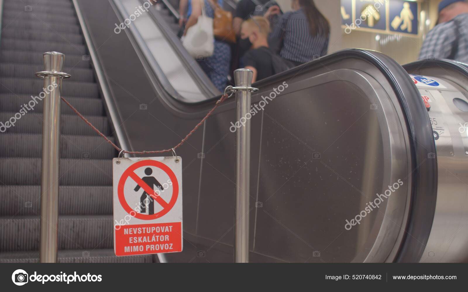 Traffic sign prohibited pedestrians on escalator. Stopping one section ...