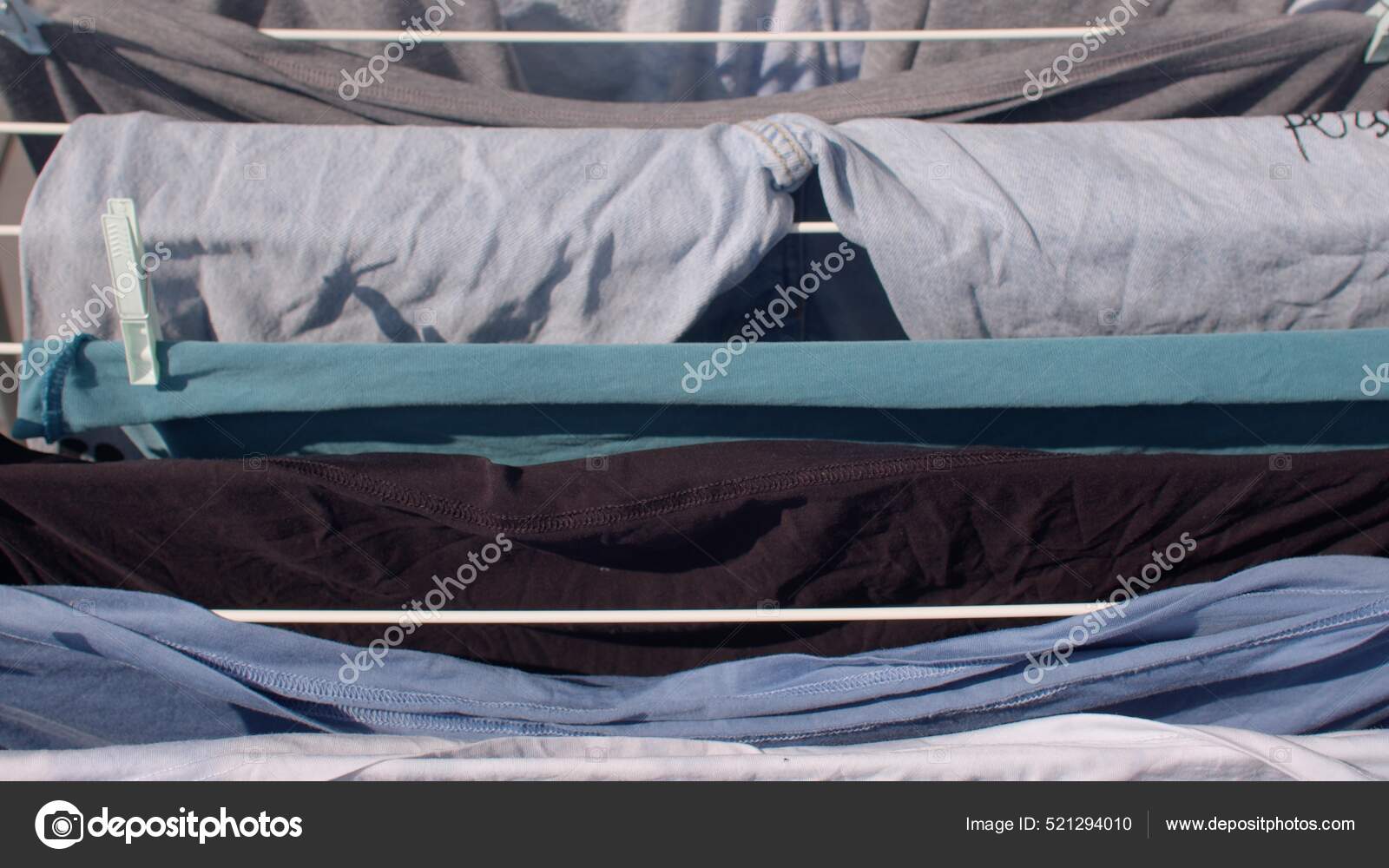 After washing, clothes dried in sun. She lies ventilated, shrinks in ...