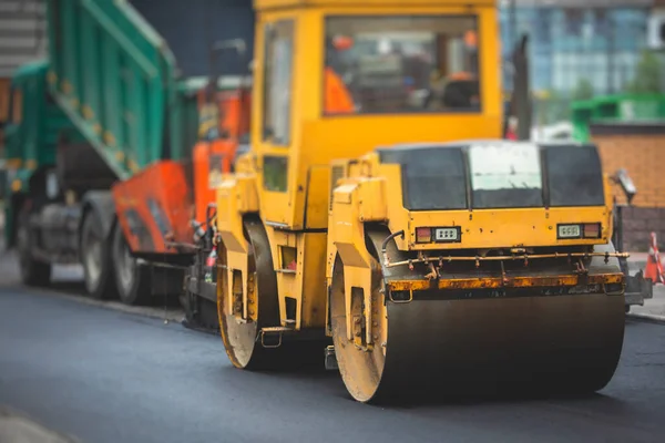 Process of asphalting, blacktopping and paving, asphalt paver machine ...