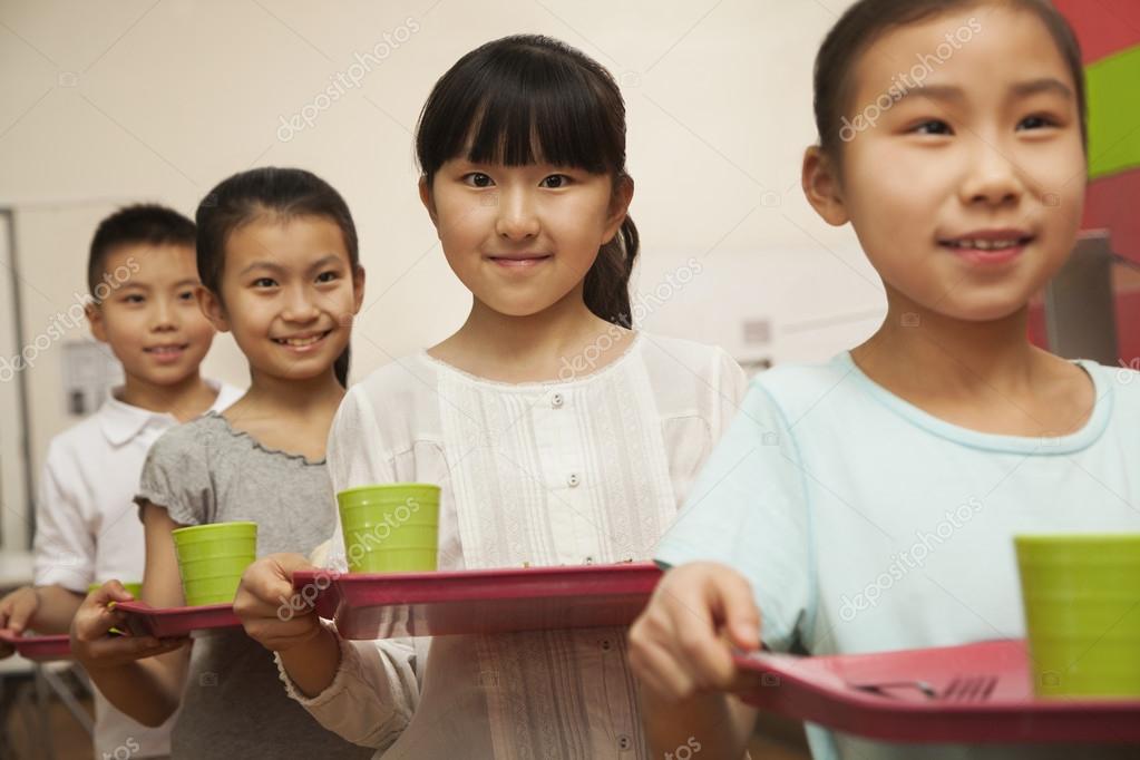 Row of students standing in line in school cafeteria — Stock Photo ...
