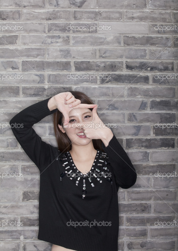 Woman Making Finger Frame with Hands — Stock Photo © XiXinXing #36399271
