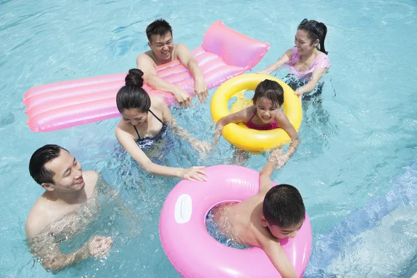 Family and friends playing at the pool - Stock Image - Everypixel