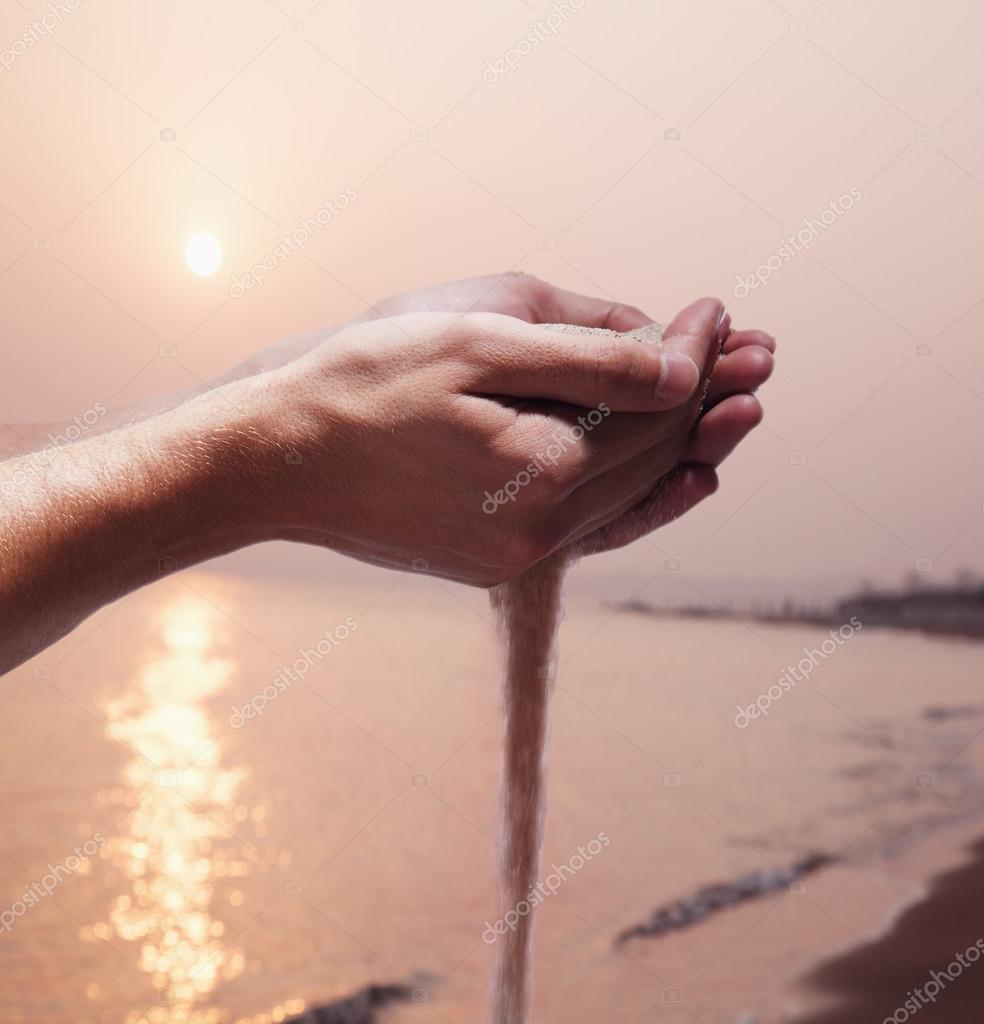 Hands holding and spilling sand — Stock Photo © XiXinXing #36656199