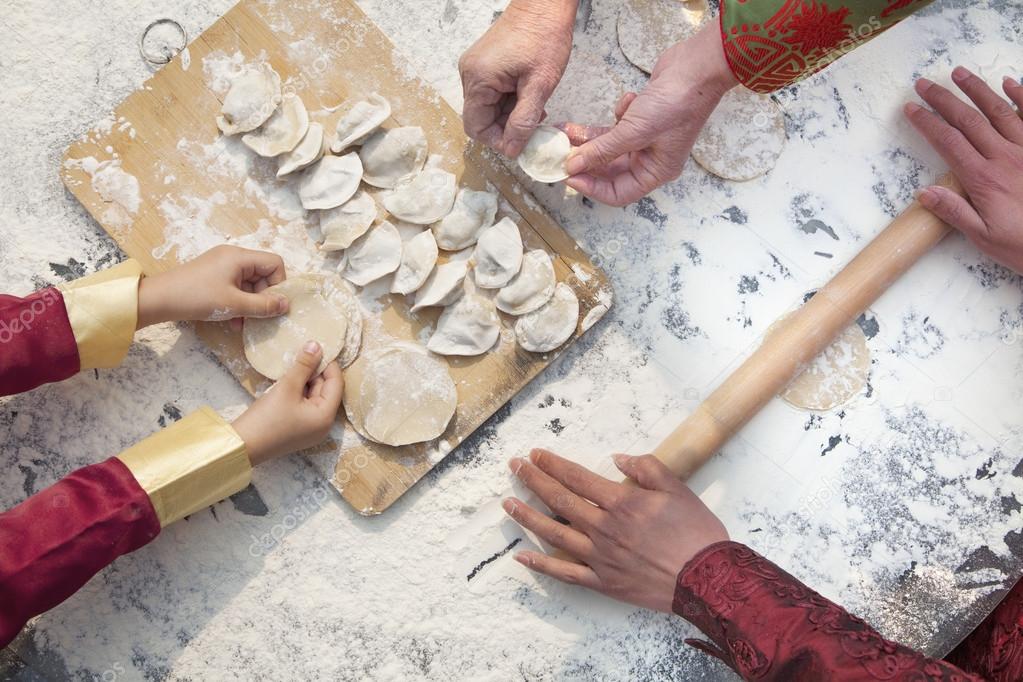 Three generation of women making dumplings — Stock Photo © XiXinXing ...