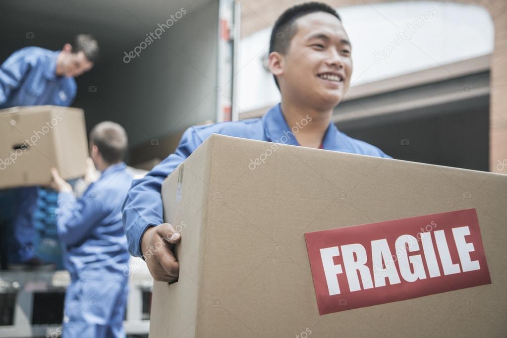 Movers unloading a moving van — Stock Photo © XiXinXing #36657741