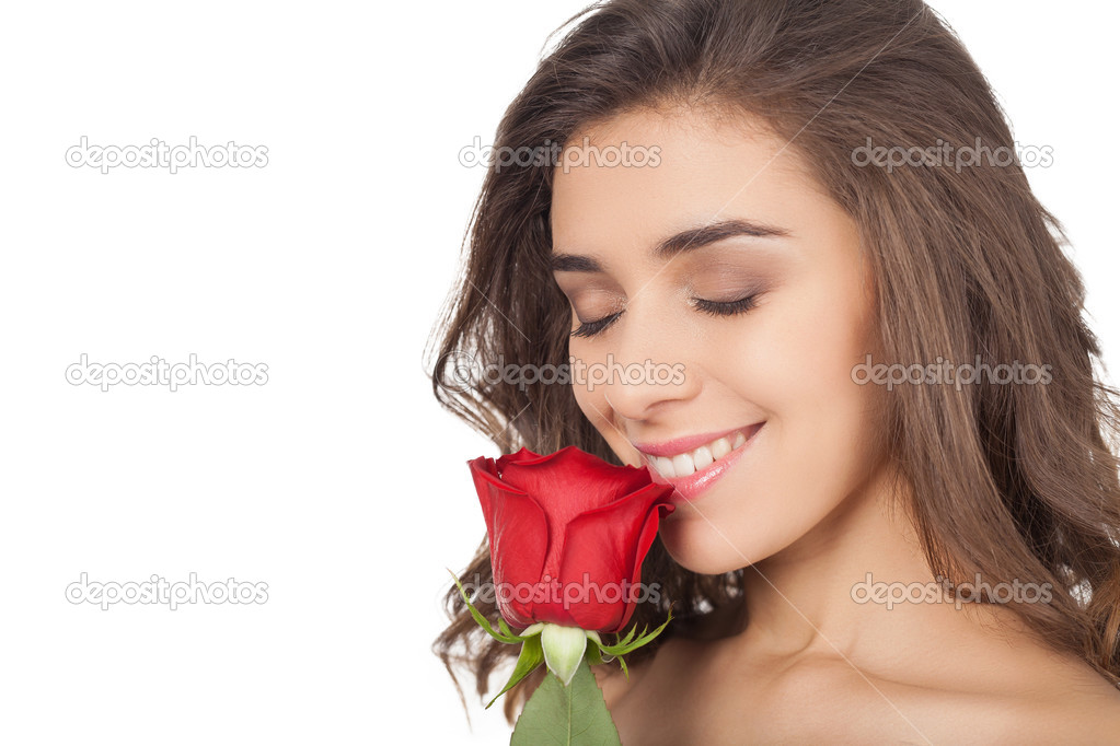Beautiful young woman holding a red rose near nose — Stock Photo ...