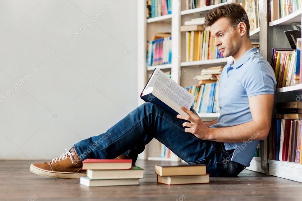 Young man in library. Stock Photo by ©gstockstudio 44027005