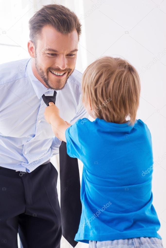 Boy helping father to tie a necktie Stock Photo by ©gstockstudio 48113831