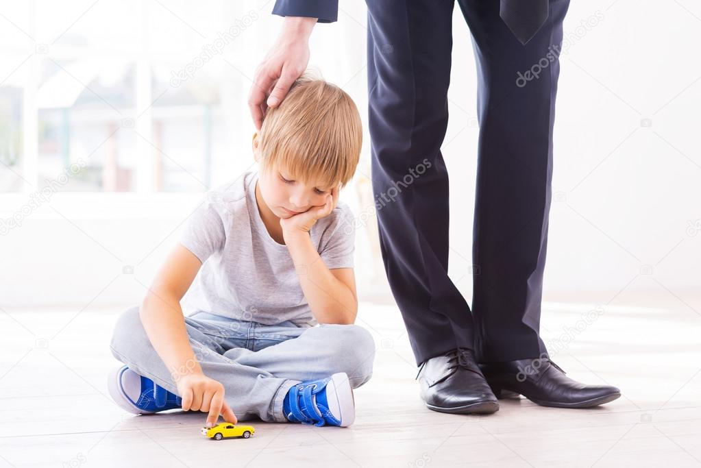 Sad little boy playing with toy car — Stock Photo © gstockstudio #48113835
