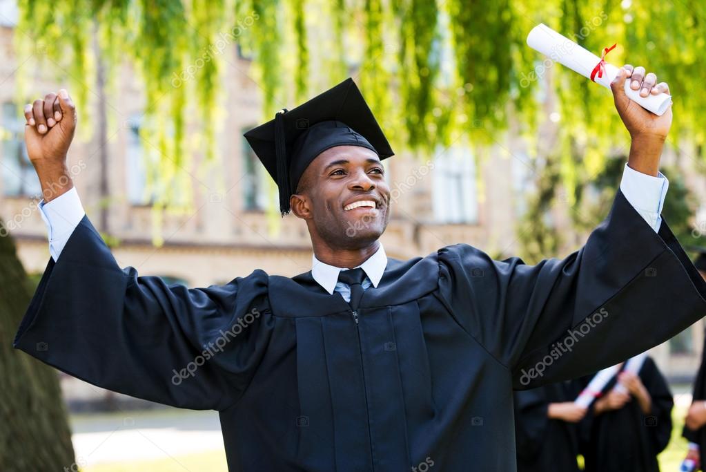 Young African man in graduation gown Stock Photo by ©gstockstudio 50656023