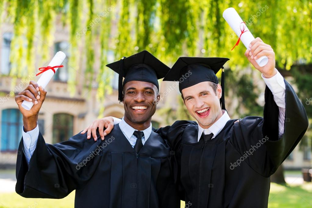 Young men in graduation gowns Stock Photo by ©gstockstudio 50656187