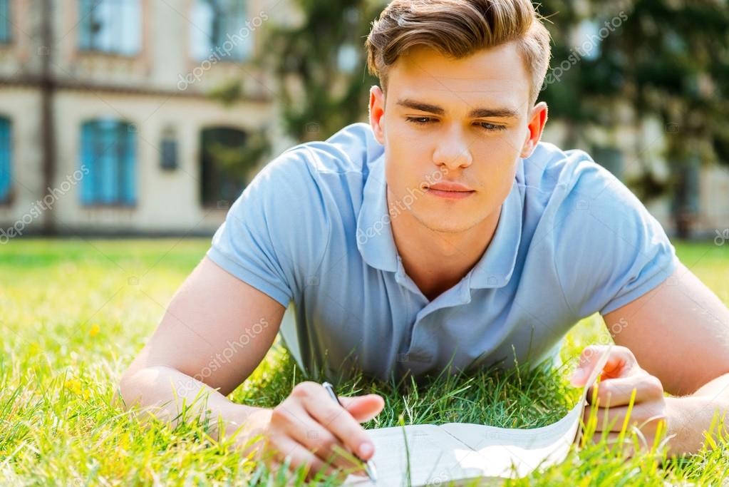 Man writing something in his note pad Stock Photo by ©gstockstudio 51425365
