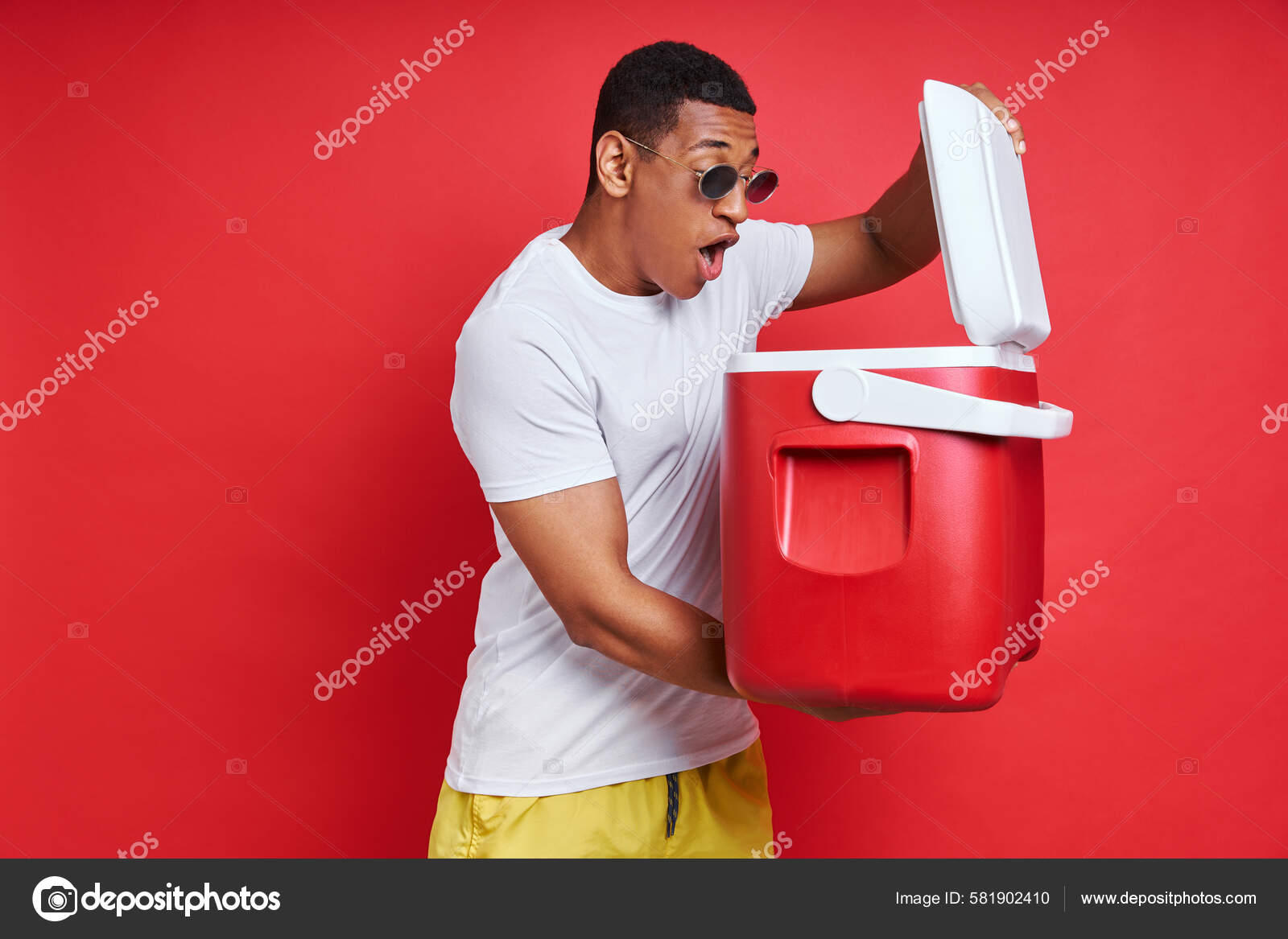 Surprised African Man Looking Cooler Box While Standing Red Background ...